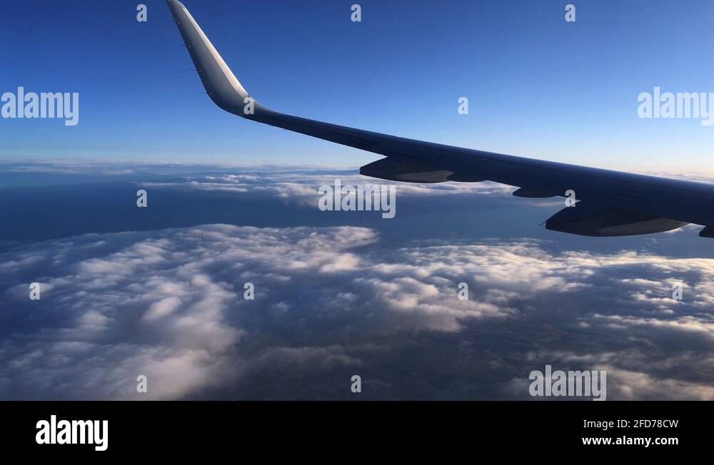 Pretty view out the window of an airliner aircraft wing side flying ...