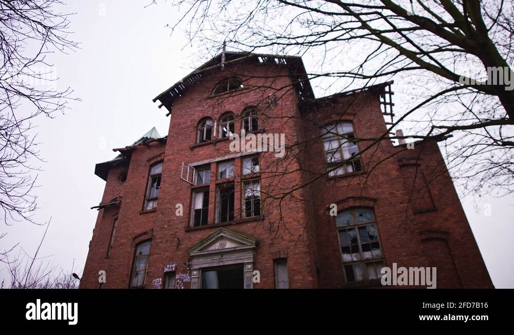 the exterior of an old haunted abandoned hotel with big windows and ...