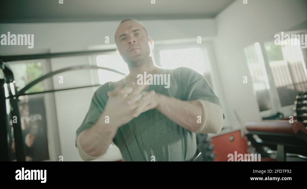 Bodybuilder is flexing his hand muscles in preparation of his heavy ...