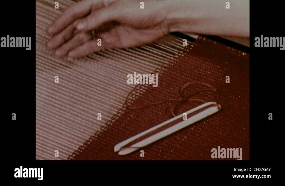 1950s: Weaver tests tension on weaving. Weaver uses shuttle in a ...