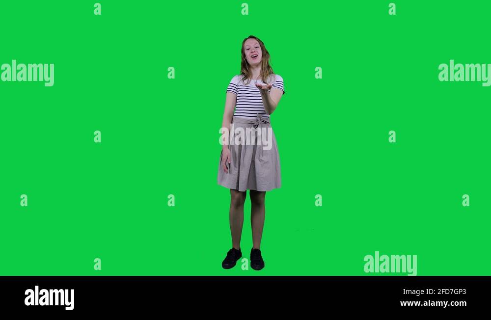 Teenage girl singing, vibing to music in front of a green screen Stock ...