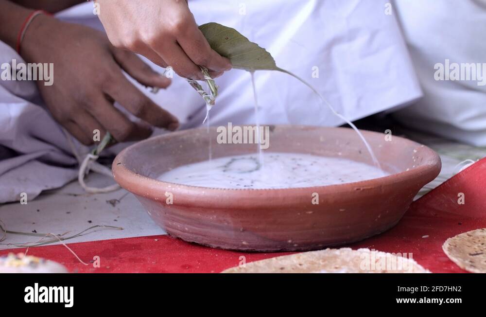 Hindu wedding ritual with milk and leaf during puja at Sri Laxmi ...