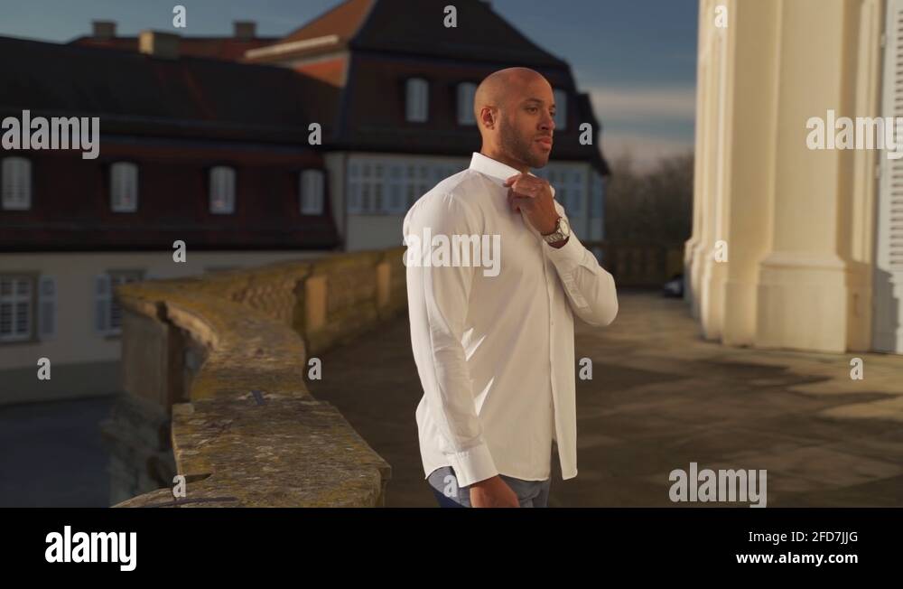 Classy male model in elegant white shirt posing at nobel castle location Stock Video Footage - Alamy