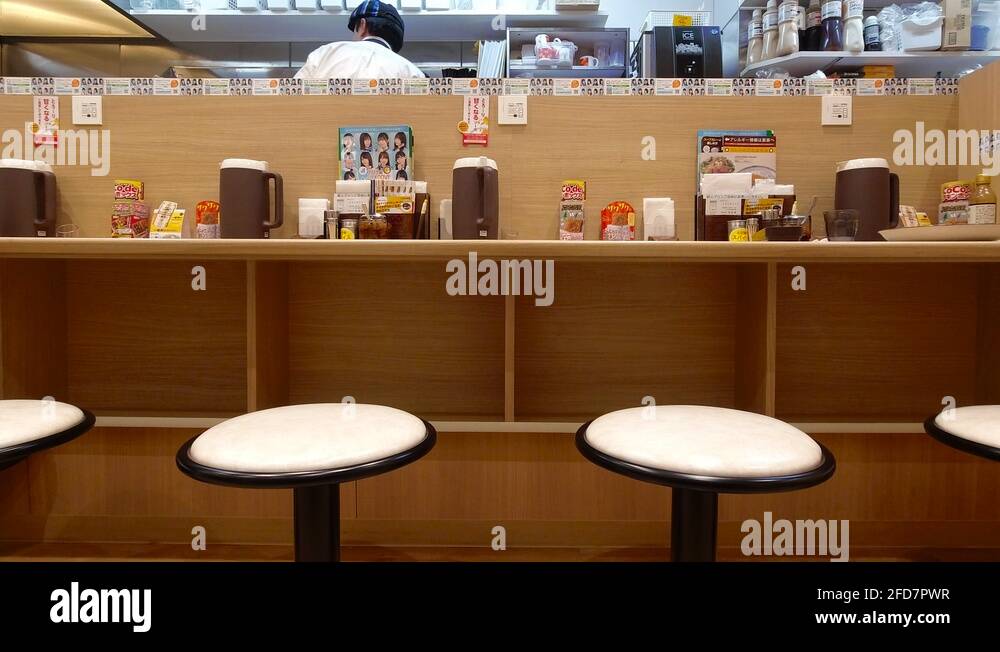 Waiter working in Japanese food chain restaurant - Locked off interior ...