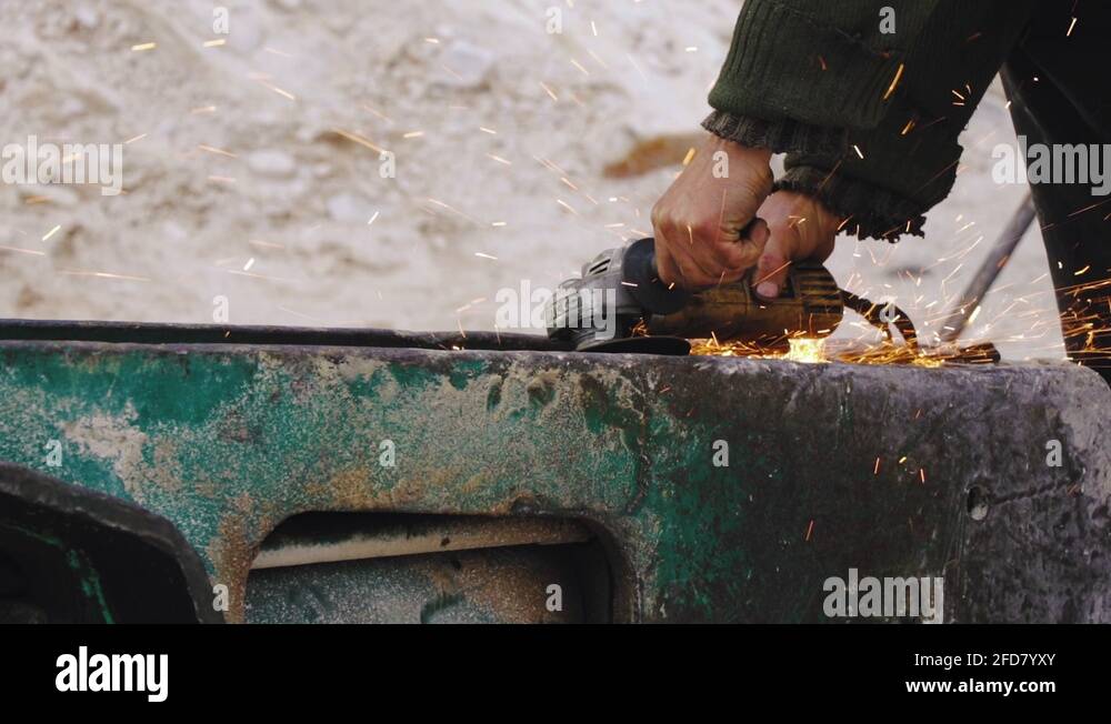 Power tool cutting a steel object. Metal grinding machine operated by a ...