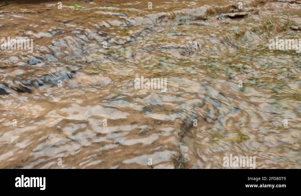 mountain spring water stream running down huge sandstone slabs of rock ...