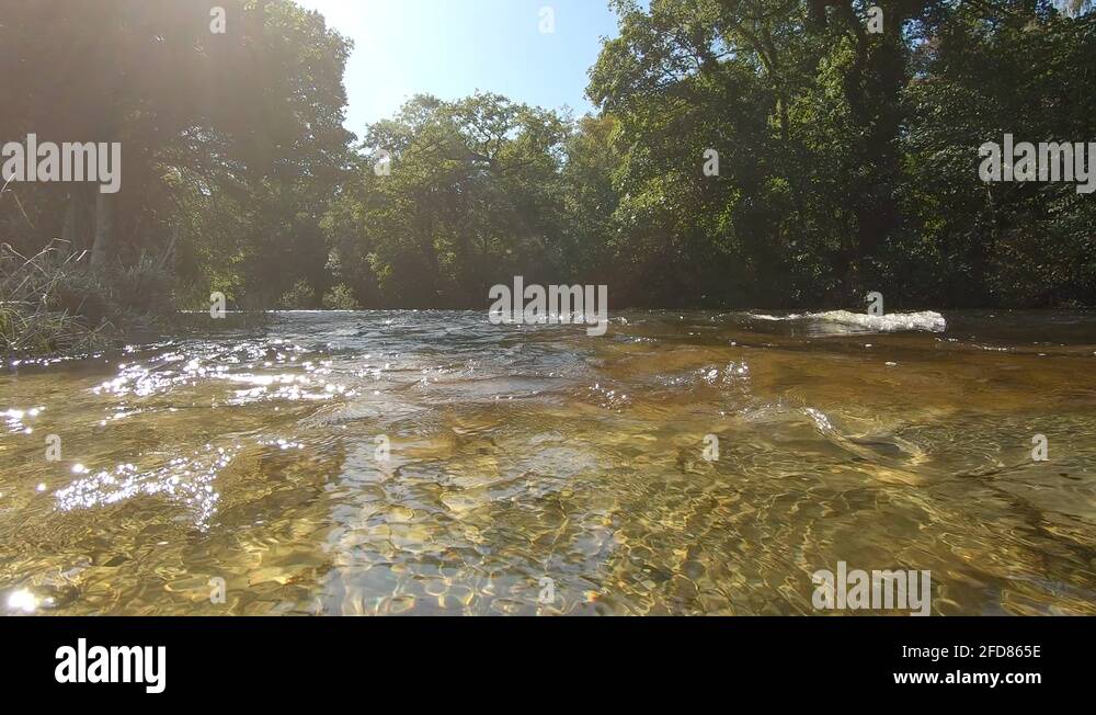 Dip below clear water streaming over shallow riverbed, underwater Stock ...
