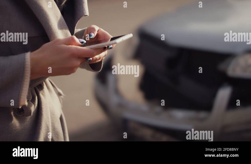 Woman texting and calling the emergency line, car crash in the middle ...