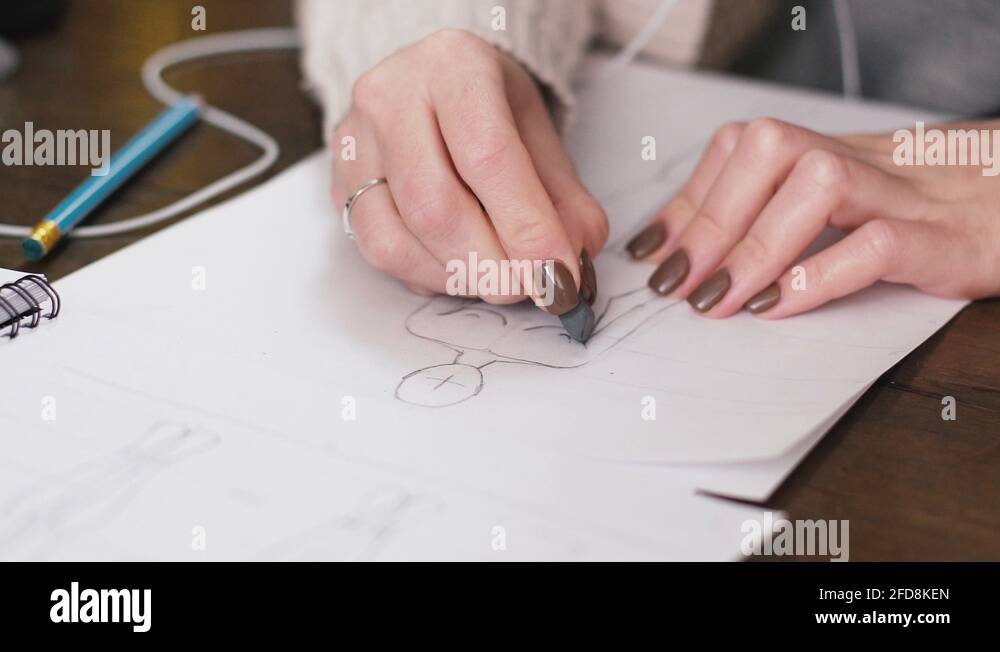 Fashion designer drawing model for clothes sketch. Hand of female ...