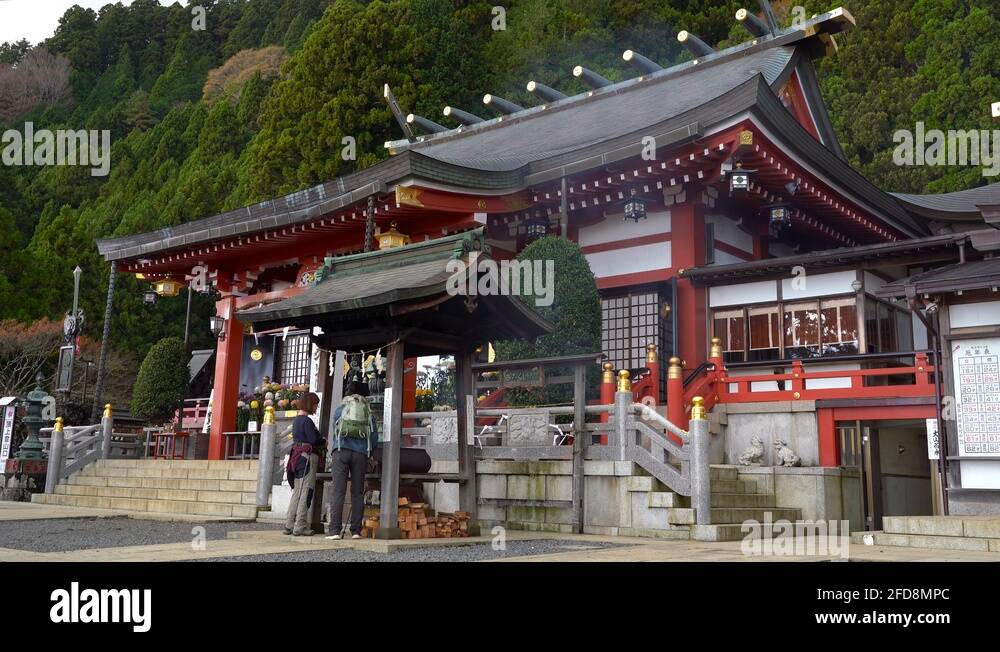 Two Japanese People Offering Prayers And Worship In Front Of The ...