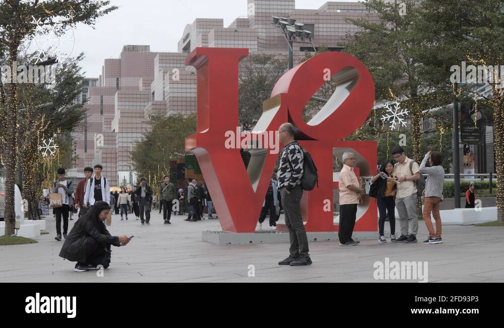 People photographing with Love text with TWTC Exhibition building ...