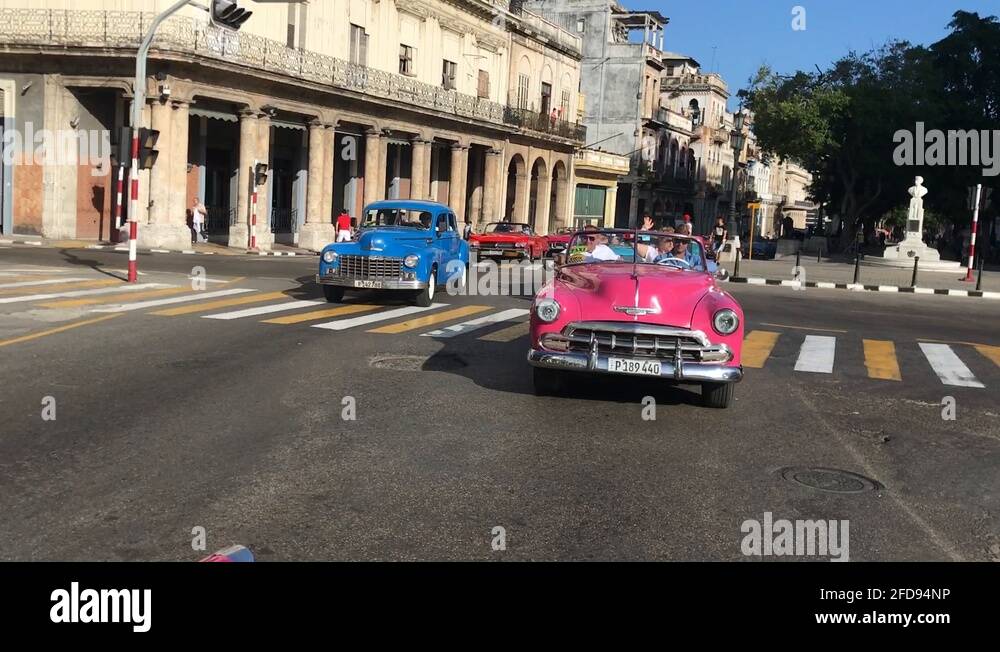 traditional classical old fashioned red and blue car driving around the ...