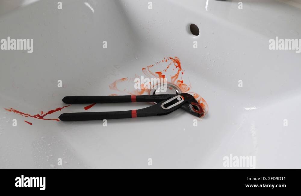 An Evil Serial Killer Cleaning His Bloody Murder Weapon in a Sink ...