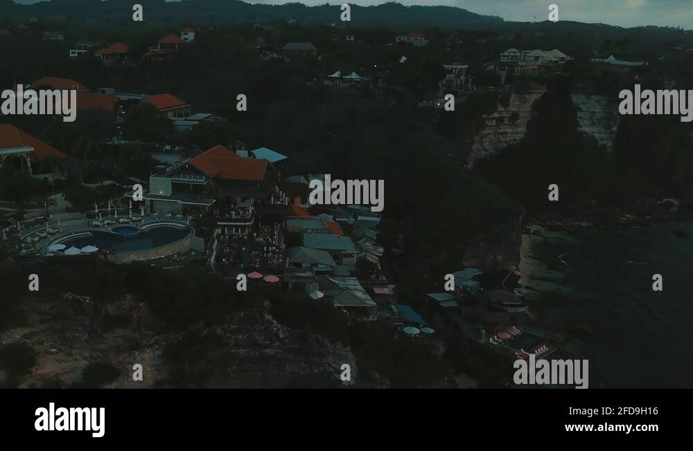 Orbiting sunset drone shot of Single Fin Club in Uluwatu, Bali to ocean ...