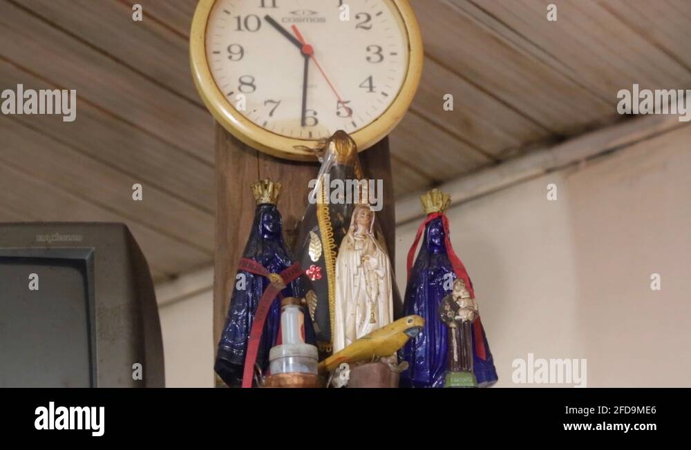 Virgin Mary by a wall clock in a kitchen Stock Video Footage - Alamy
