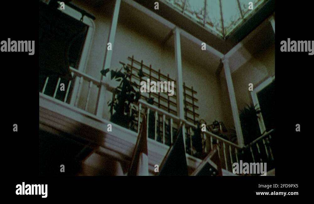 1980s: Ornate building, atrium, interior courtyard, balconies, flags ...