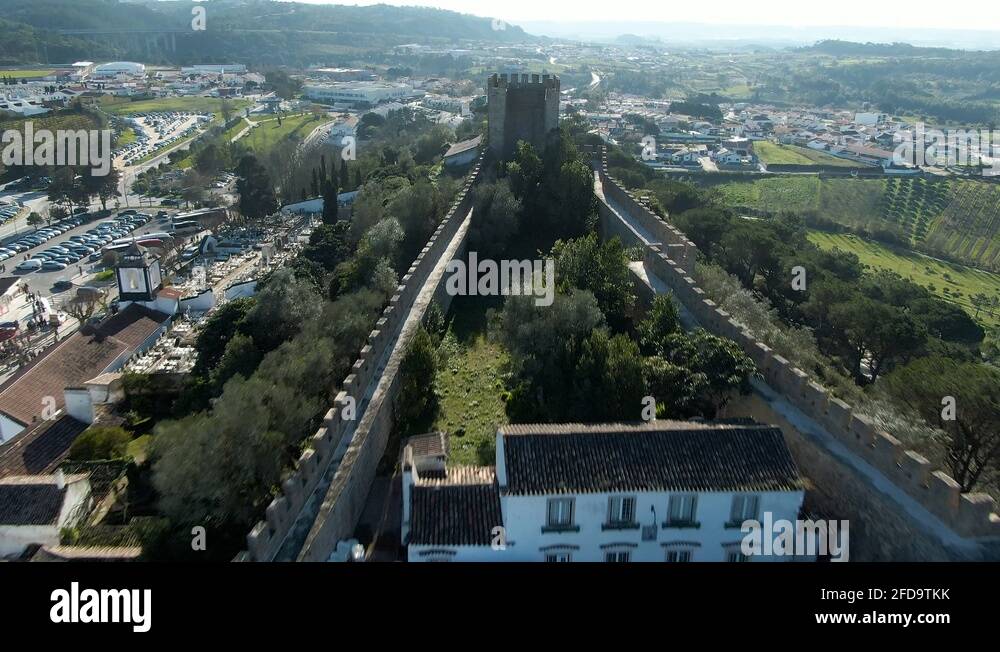 Stronghold with thick stone walls and main gate standing on top of the ...