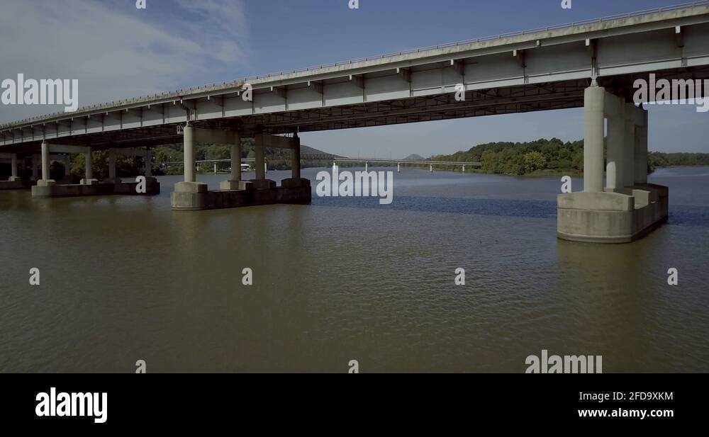 Flying underneath highway bridge close to water. Slowly revealing Stock ...