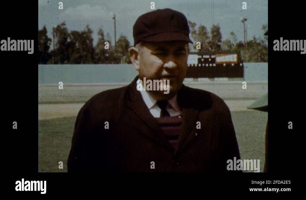 1970s: Close up of umpire talking. Baseball coaches shake hands ...