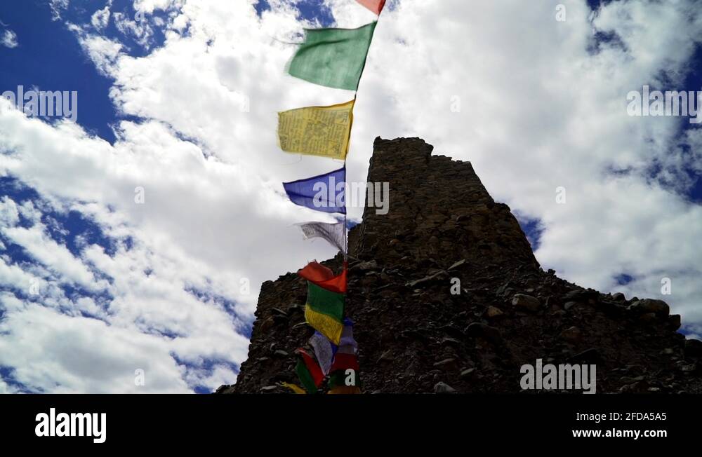 Tibetan prayer flags in the wind at Buddhist monastery ruins in the ...