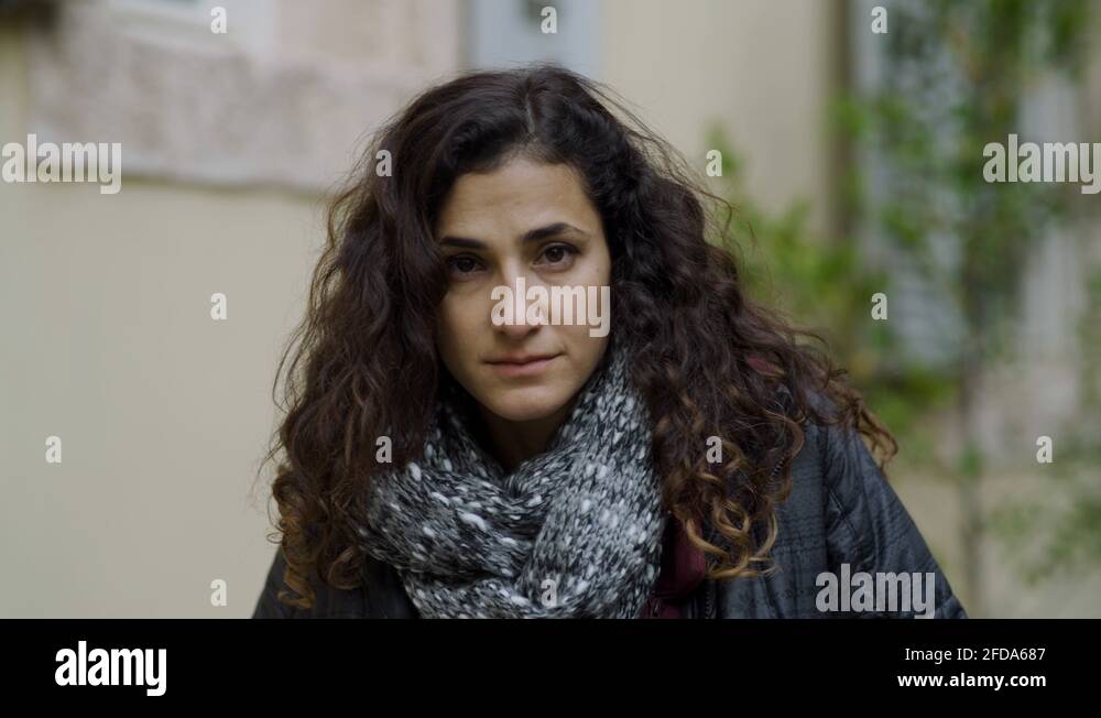 Young middle eastern woman staring sadly at the camera. outdoor. 4K ...