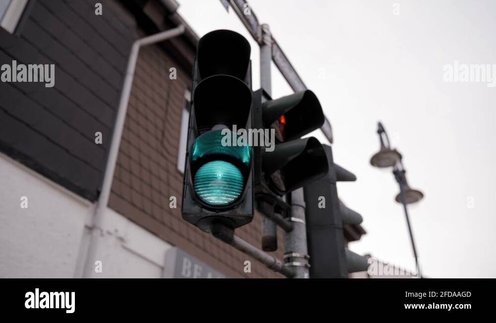 german traffic light changing colors while planes flys in background ...