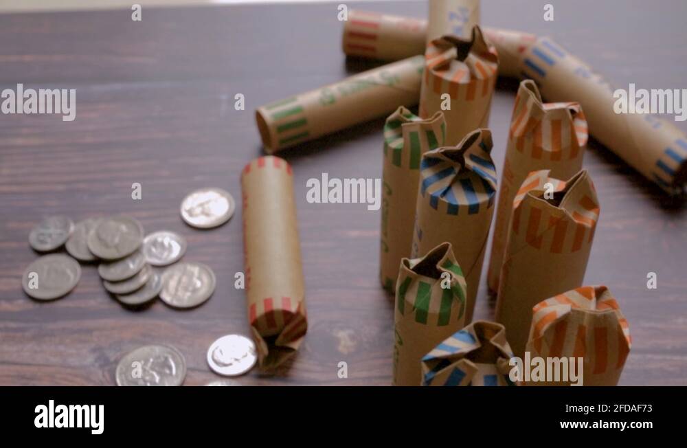 Coins rolled up in change roller tubes Stock Video Footage - Alamy