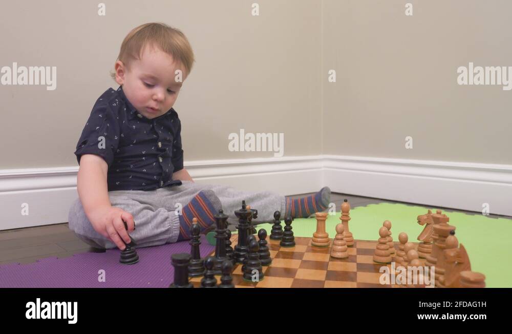 Curious baby boy exploring a chess board Stock Video Footage - Alamy