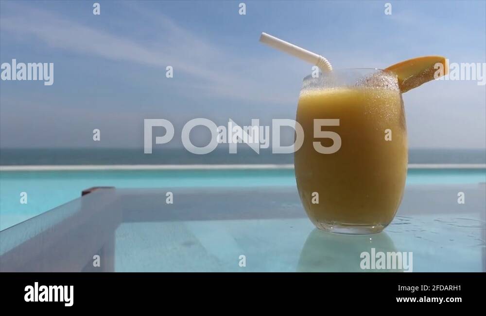 mango smoothies glass with swimming pool and sea beach background Stock ...