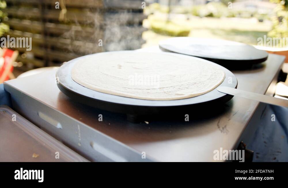 summer crêpes booth making delicious french crêp on a crepmaker in 4K ...