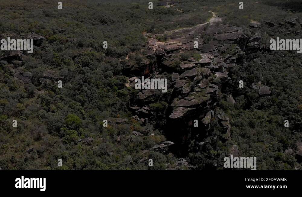 Sideways aerial pan showing the huge plateau with sticking out rock ...