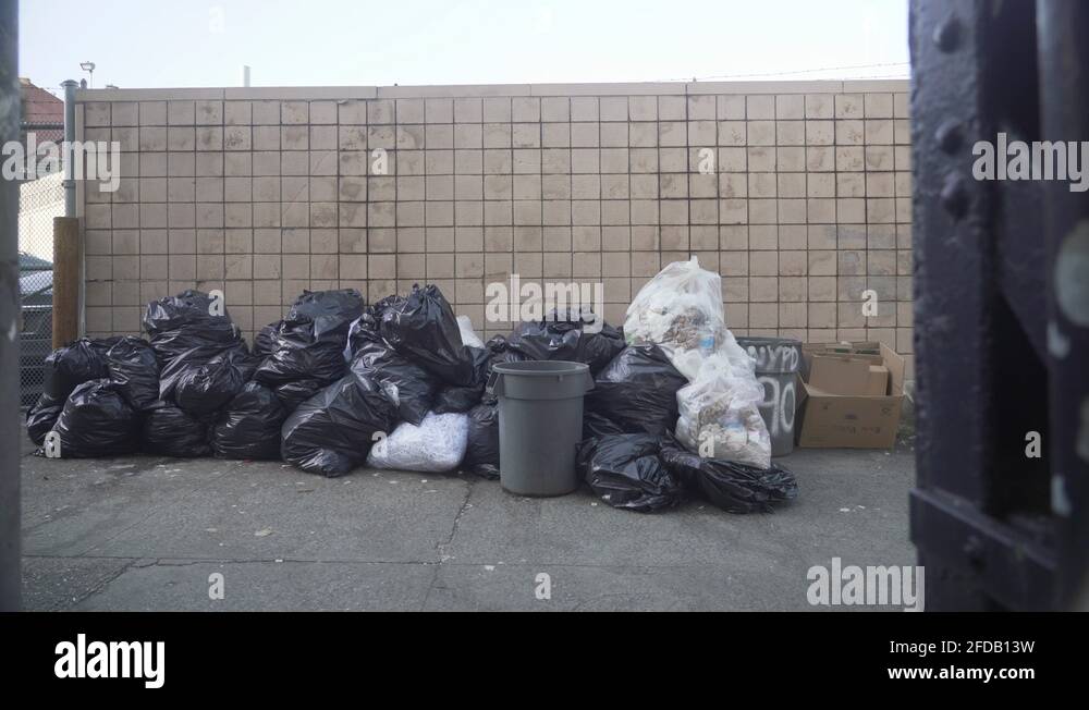 Bags of Trashes in NYC Street with Walker by Stock Video Footage - Alamy