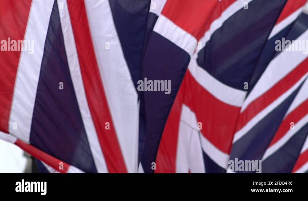 Red, white and blue British Union Jack flags flutter in the wind on ...