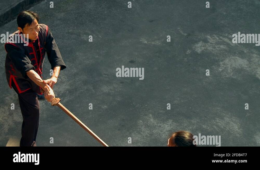 Fighting scene of a master and his pupil with chinese sowrds in a ...