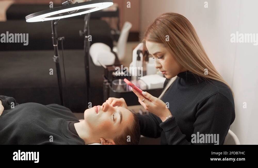 Girl eyelash extension artist takes pictures of her completed work on ...