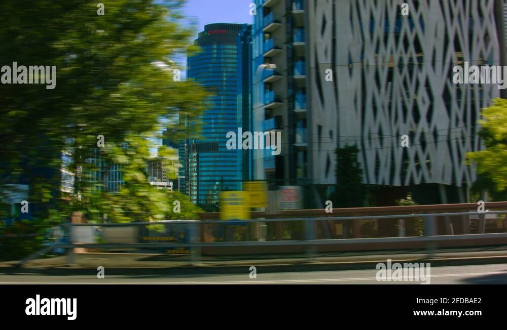 Side view through window of modern city street while driving, daytime ...