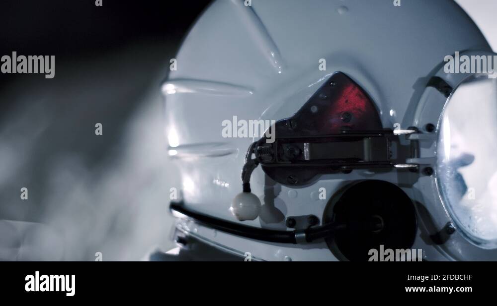 Portrait of the Caucasian spaceman in the white space helmet on his ...