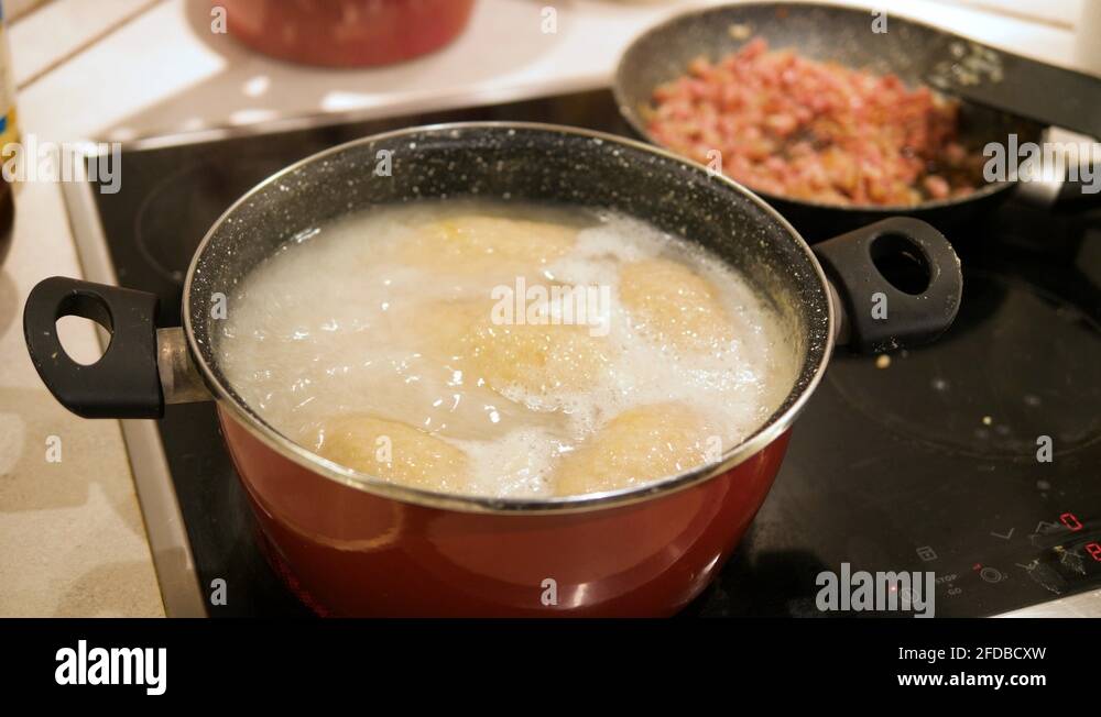 Close-up of boiling Cepelinai. Traditional food Zeppelins national ...