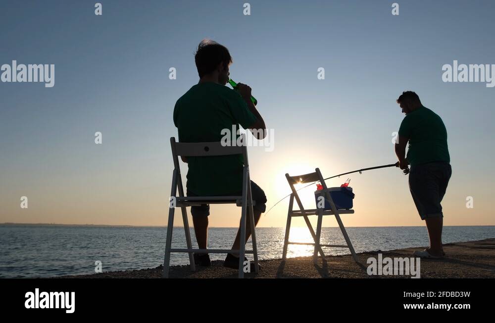 Two men catch fish in the sea Stock Video Footage - Alamy