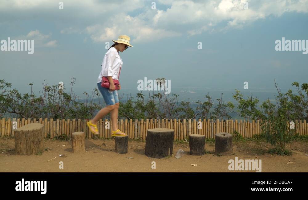 Girl jumping rom log to log and then holding arms up in success Stock ...