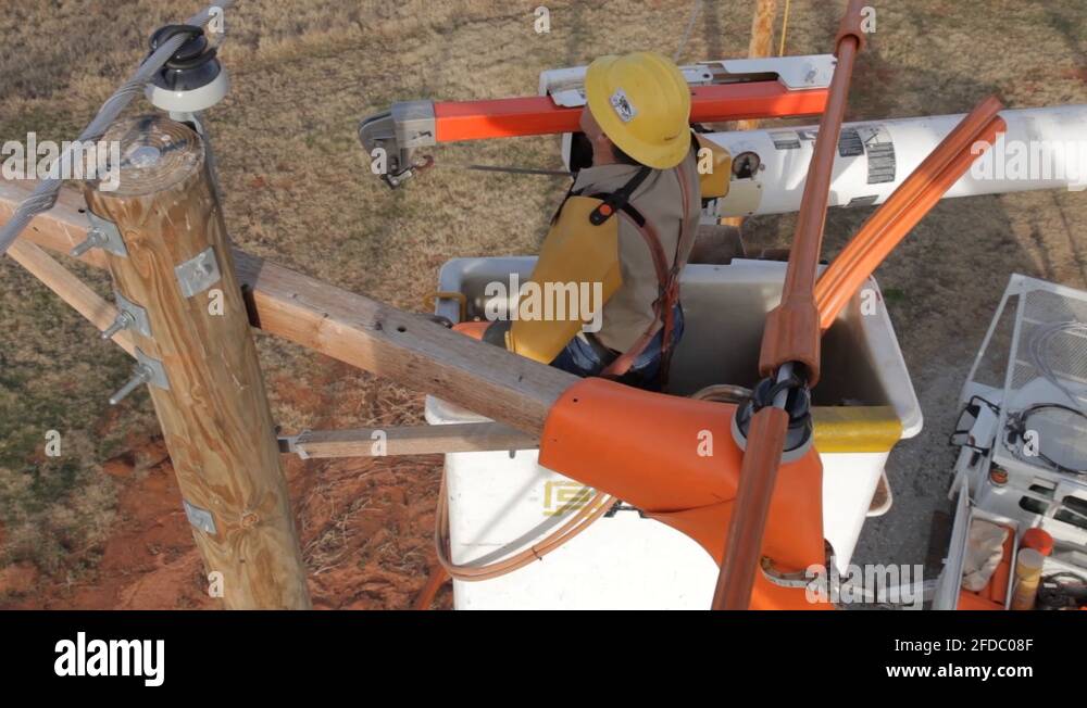 Electrical Lineman Working On Power lines on Utility Pole Stock Video ...
