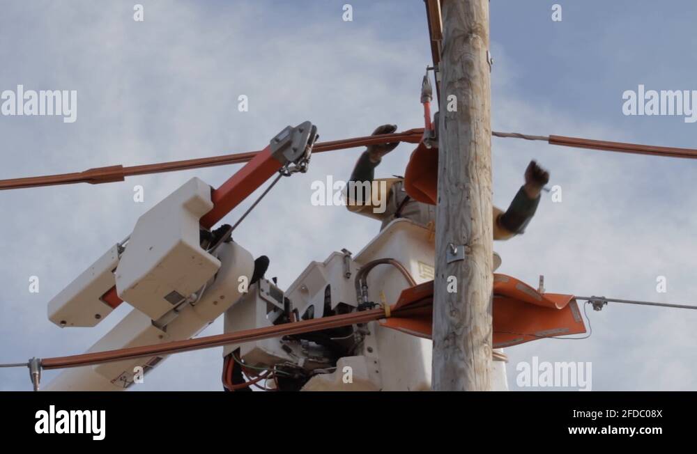 Electrical Lineman Working On Power lines on Utility Pole Stock Video ...