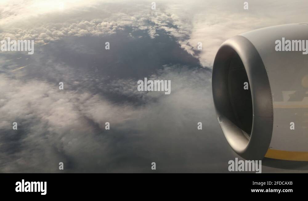 Airplane engine seen from window flying above clouds. Static shot Stock ...