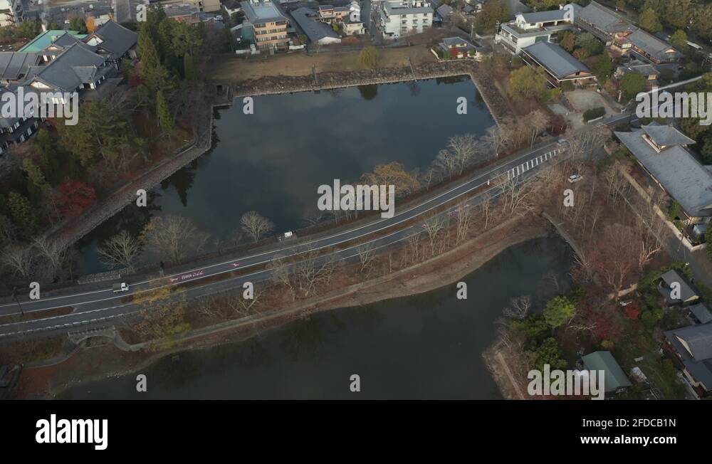 An aerial tilt of the scenic and ancient city of Nara, Nara Prefecture ...