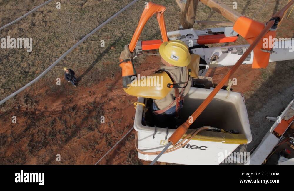 Electrical Lineman Working On Power lines on Utility Pole Stock Video ...