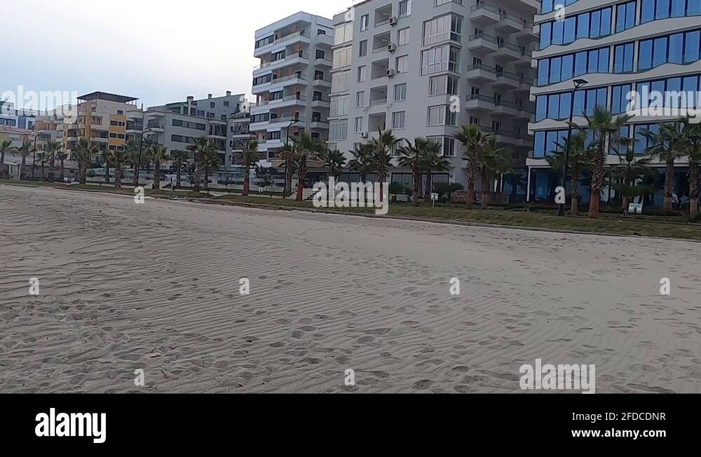 The beautiful hotel buildings of Qerret, Albania overlooking the waves ...