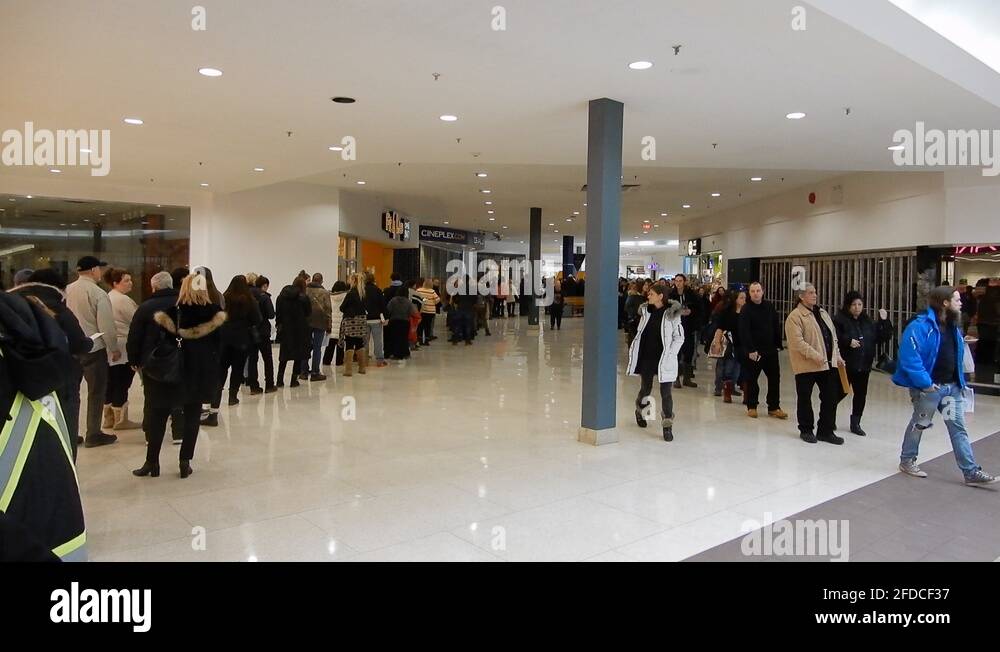 Long Line of People Waiting in Line in Shopping Mall for Job ...