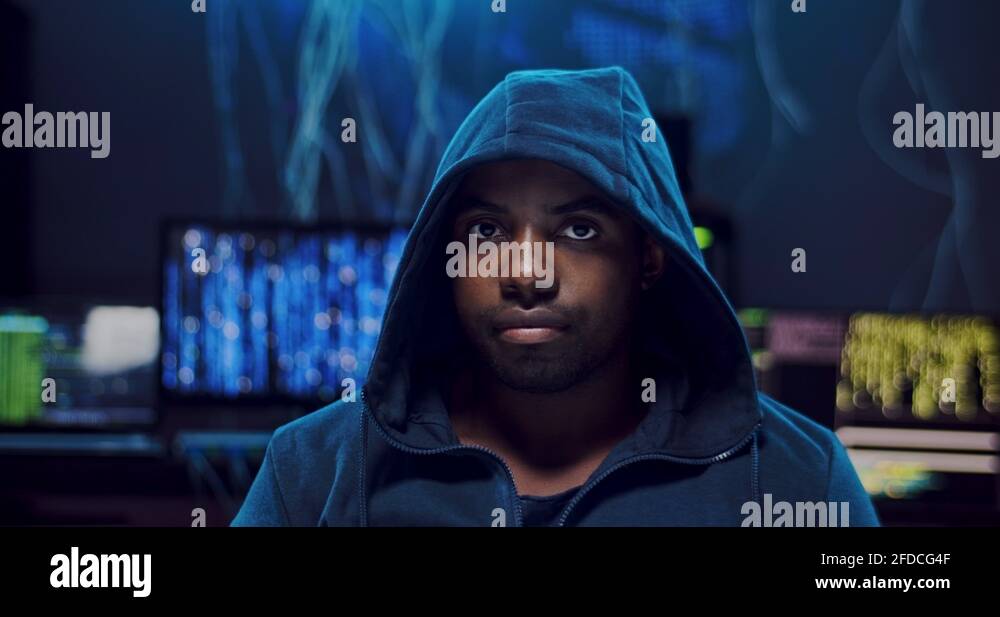 Portrait of the young good looking African American male hacker in a ...