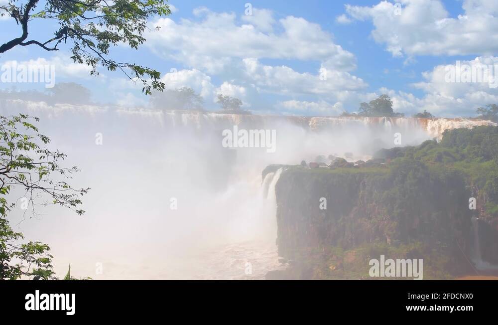 The Beautiful Scenery Of Iguazu Falls With Glorious Trees and Cloudy ...
