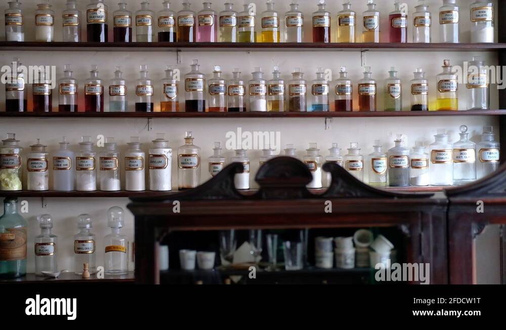 Old pharmaceutical apothecary glass pill medicinal bottles lined on ...